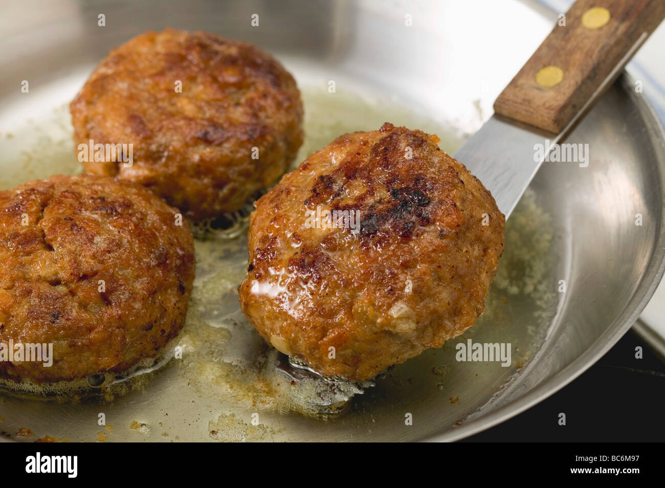 Frying burgers Stock Photo - Alamy