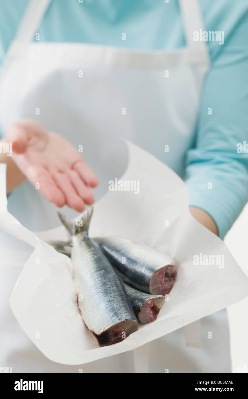 Person showing freshly cleaned anchovies Stock Photo - Alamy