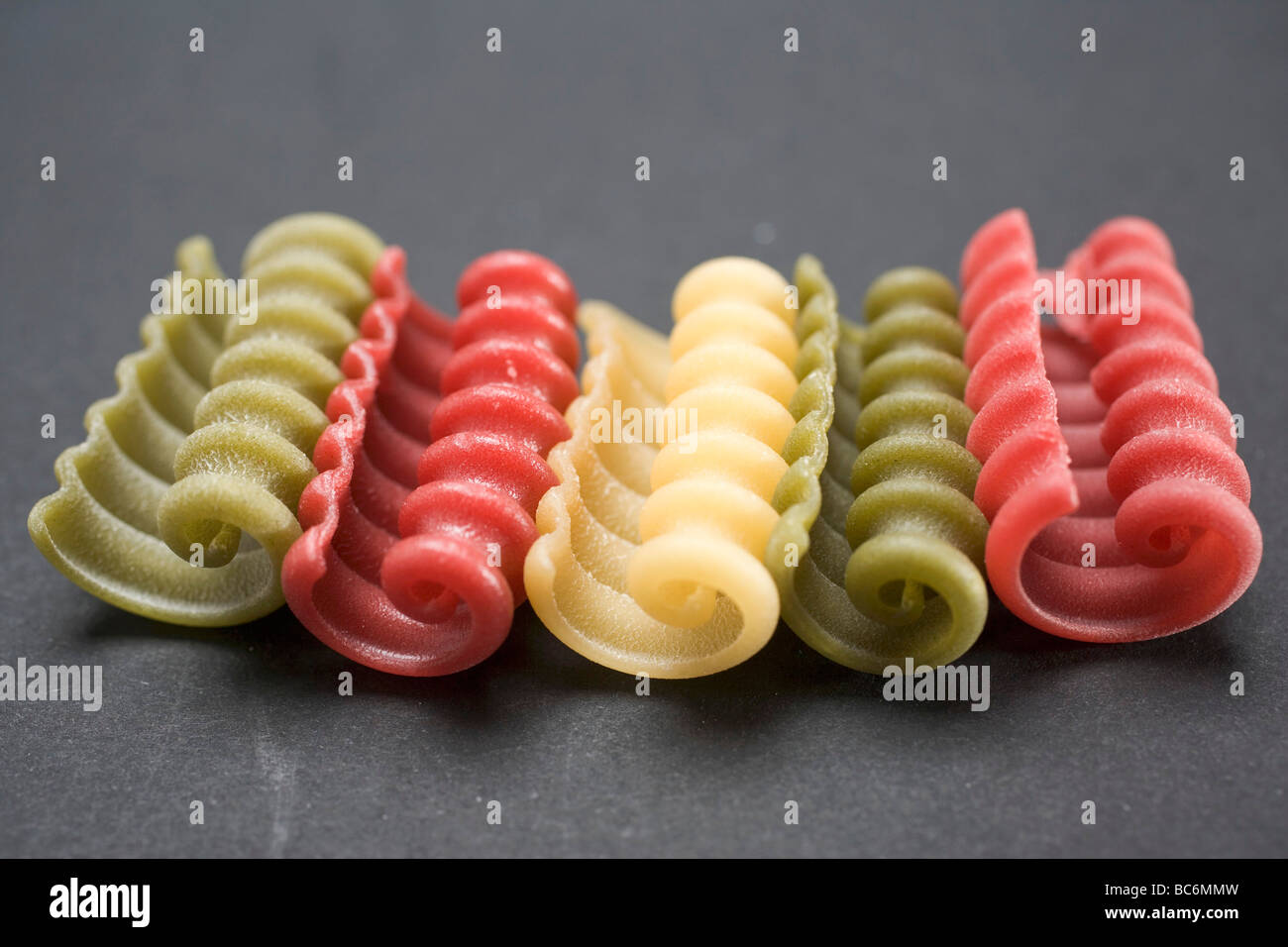 Coloured riccioli in a row Stock Photo - Alamy