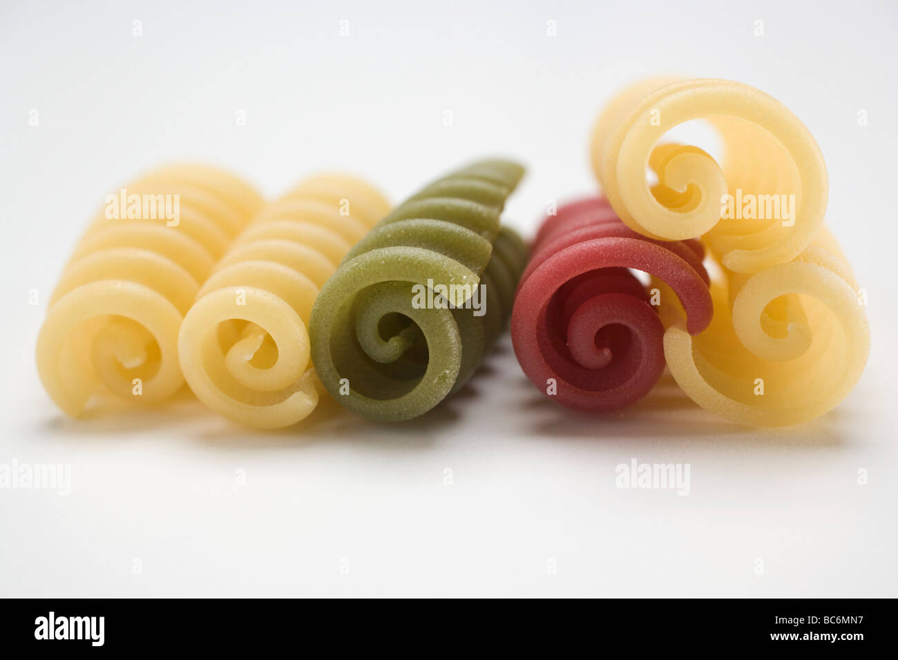 Coloured riccioli in a row Stock Photo - Alamy