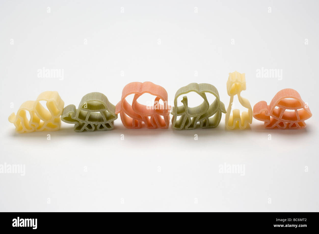 Coloured animal-shaped pasta in a row Stock Photo - Alamy