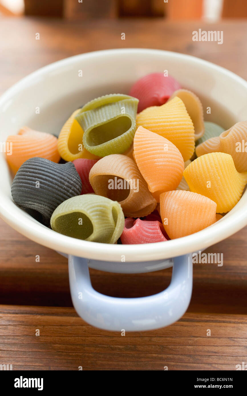 Coloured lumaconi in strainer Stock Photo - Alamy