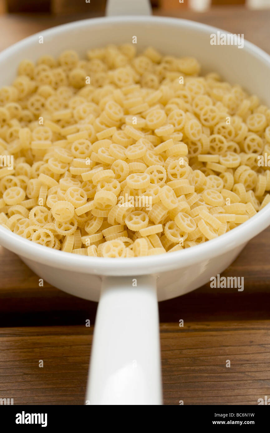 Wagon wheel pasta in strainer Stock Photo - Alamy