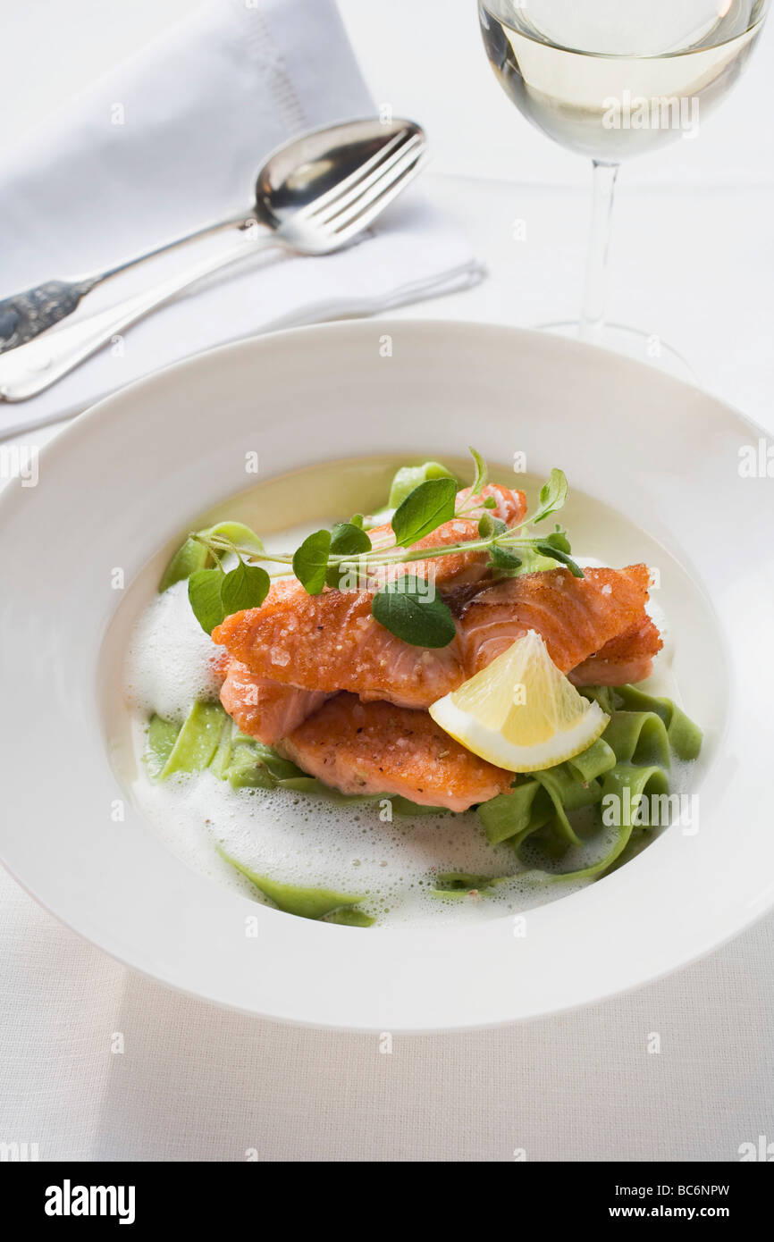 Salmon fillet on green ribbon pasta Stock Photo - Alamy