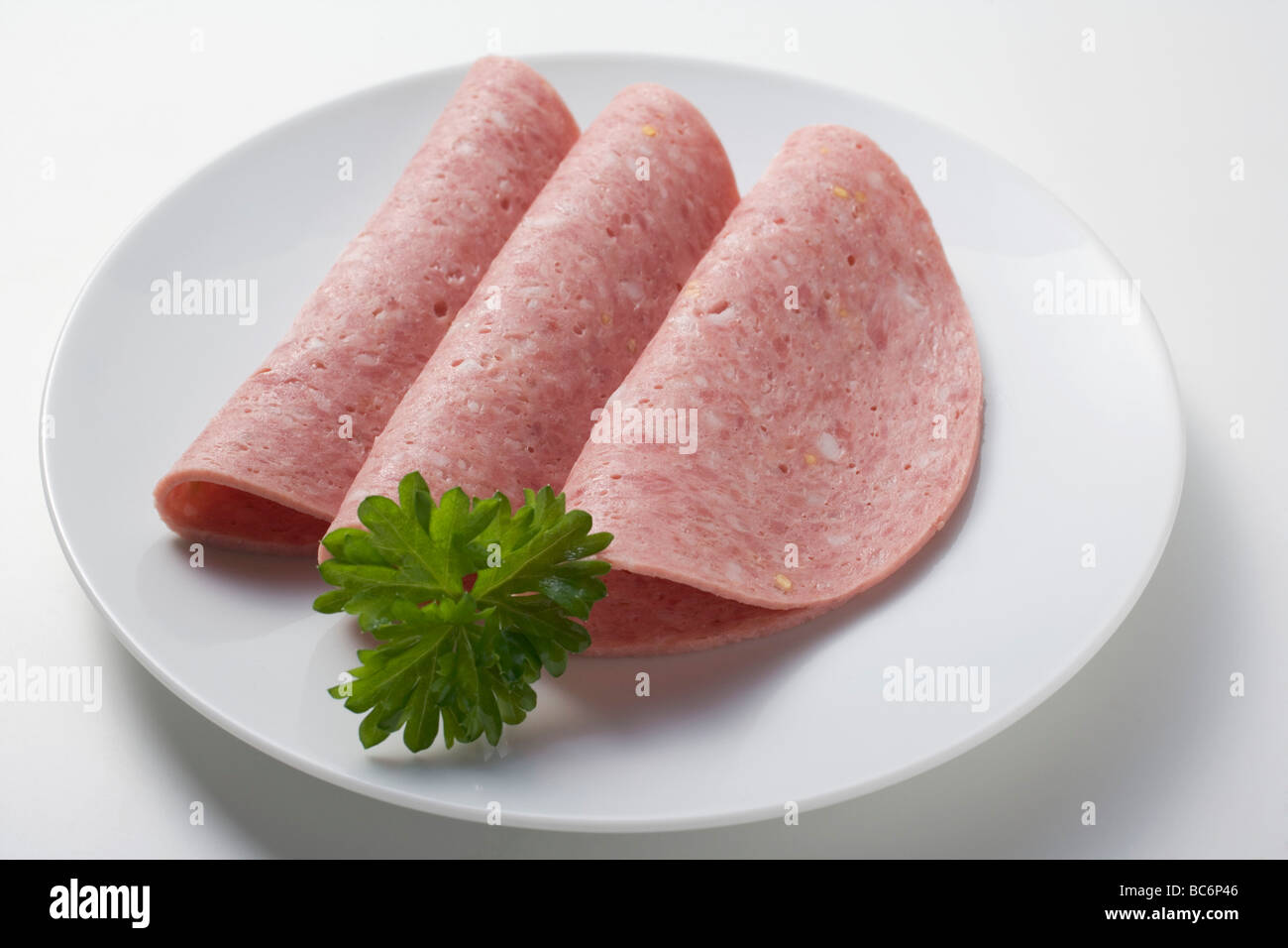 Three slices of Bierwurst (beer sausage) on plate Stock Photo - Alamy