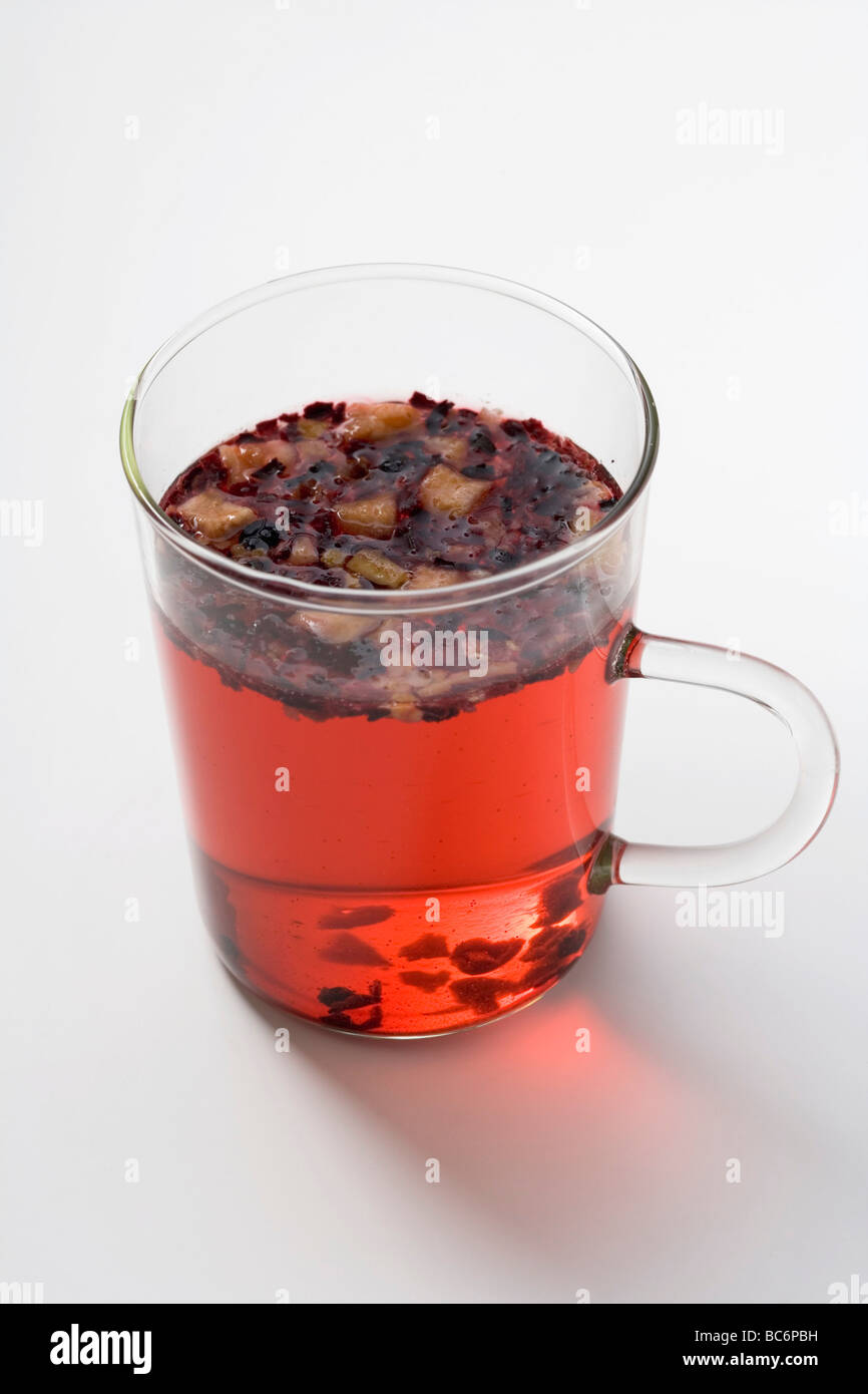 Fruit tea with tea leaves in glass cup Stock Photo - Alamy
