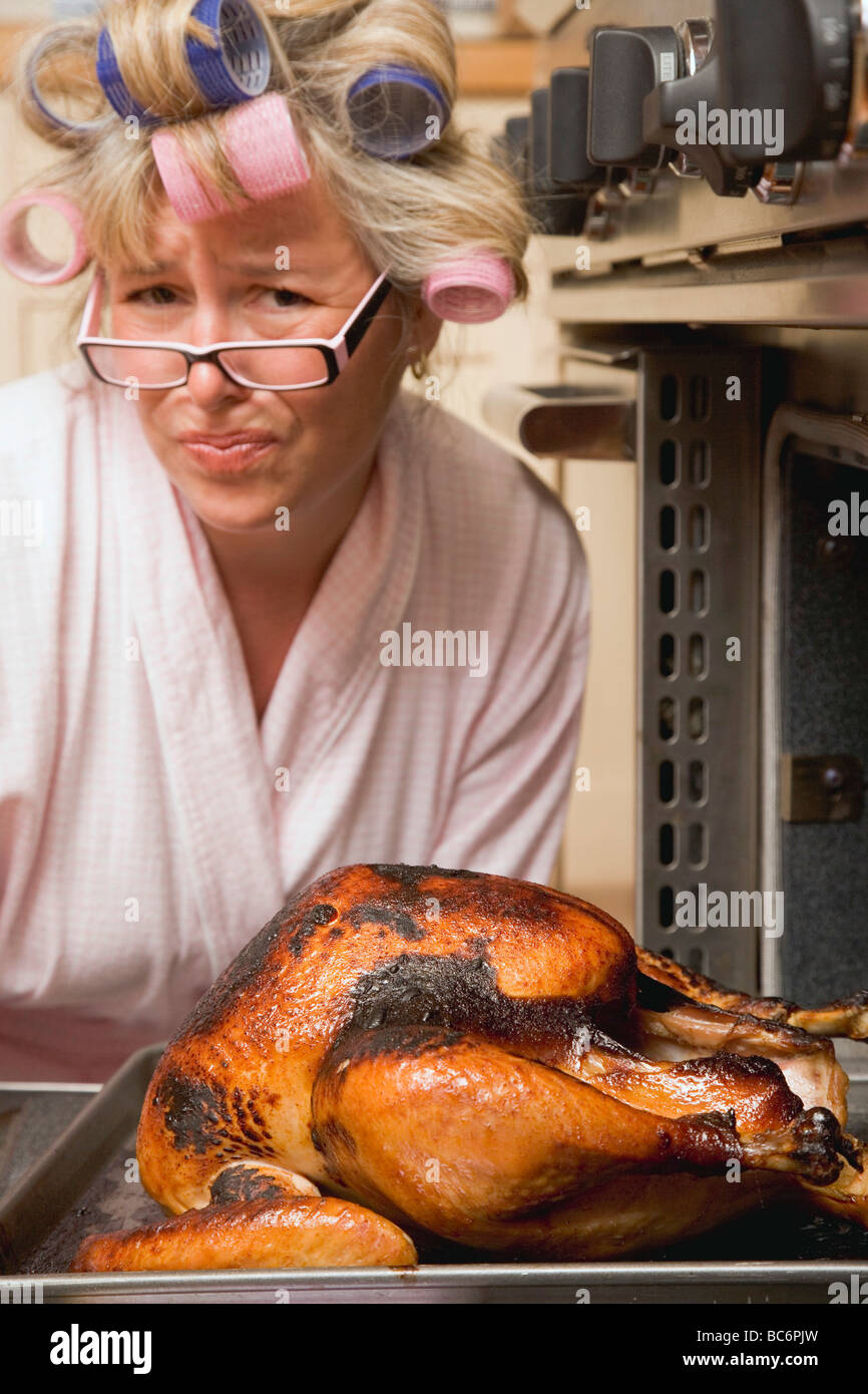 Despairing housewife with burnt turkey Stock Photo - Alamy