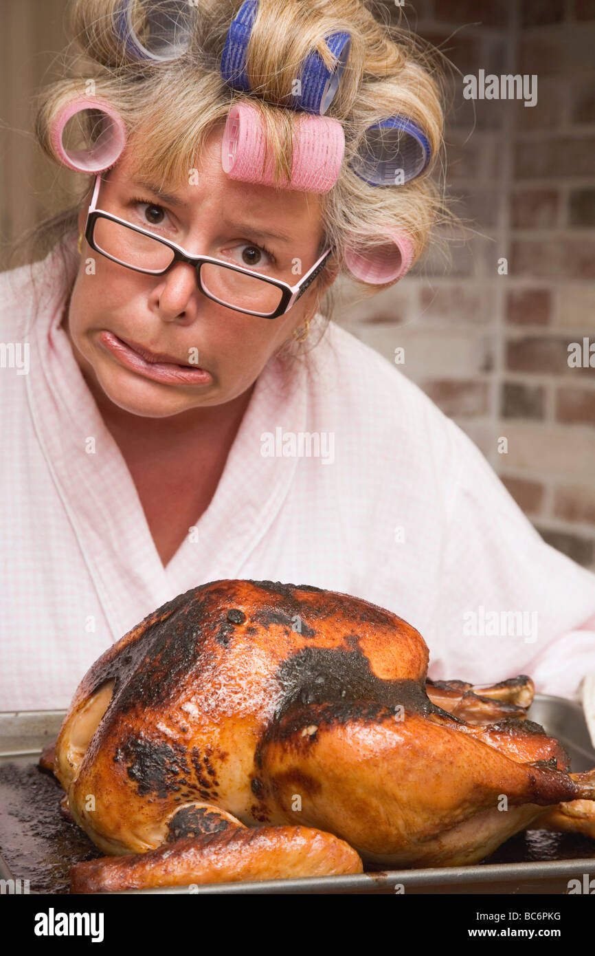 Horrified housewife with burnt turkey Stock Photo - Alamy