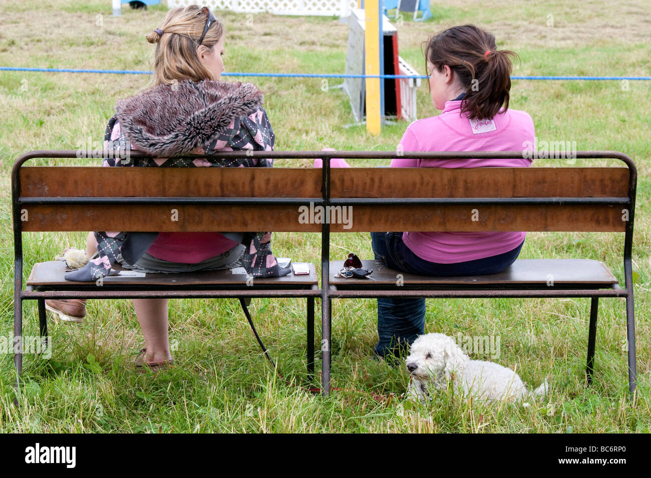 Two young women talking on park bench rear view from behind Stock Photo ...