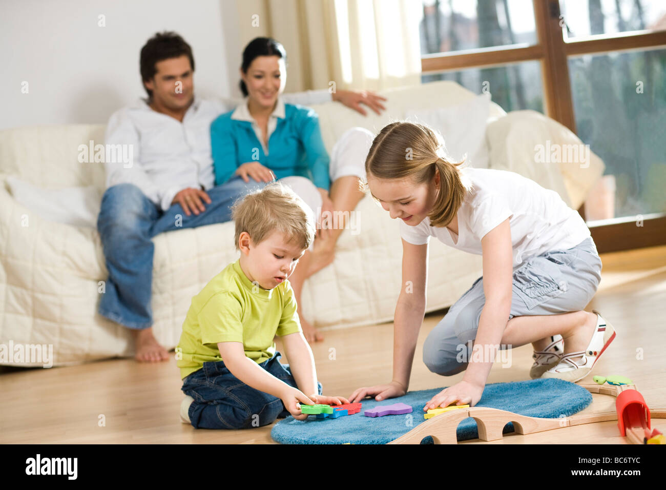 Family at home Stock Photo - Alamy
