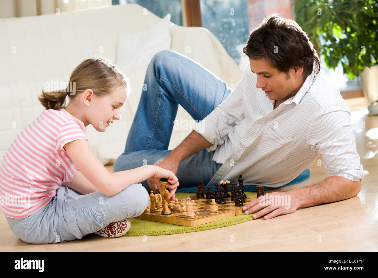 Father playing chess with daughter Stock Photo - Alamy
