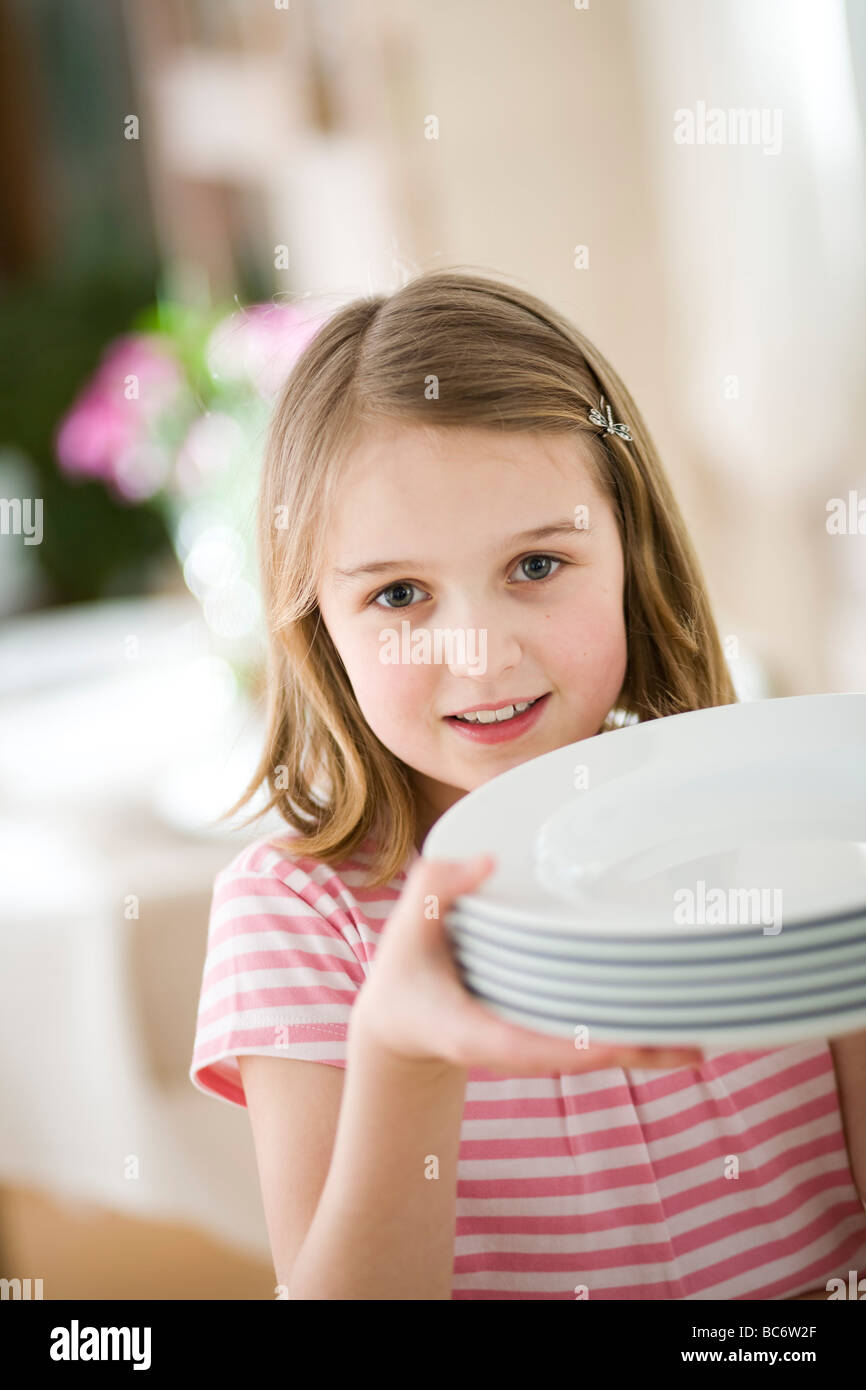 Girl laying the table Stock Photo - Alamy