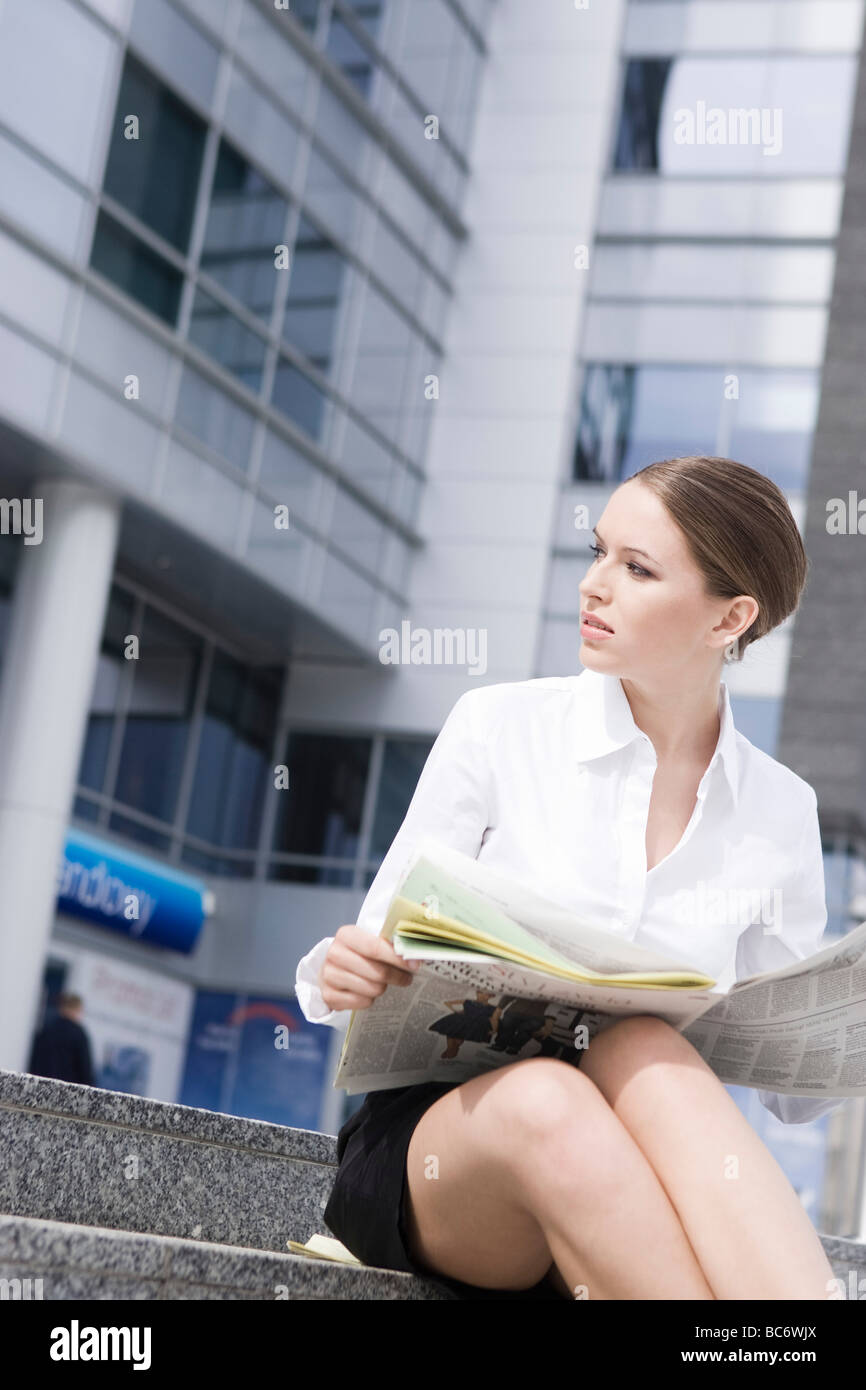 Woman reading newspaper Stock Photo - Alamy