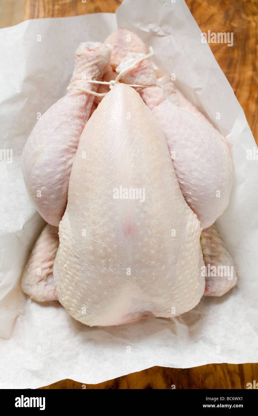 Fresh chicken on paper (overhead view Stock Photo - Alamy