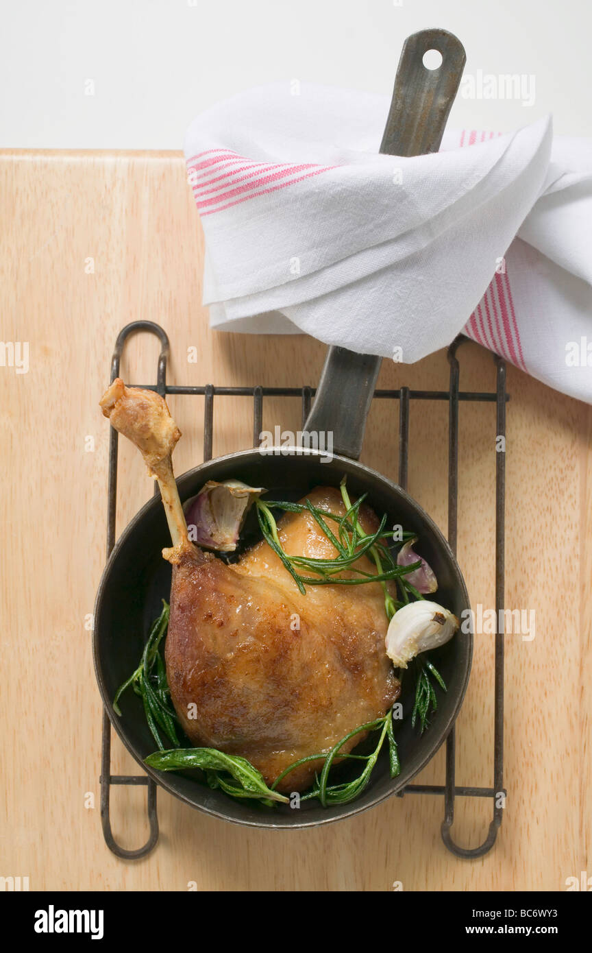 Fried goose leg with rosemary in frying pan (overhead view Stock Photo ...