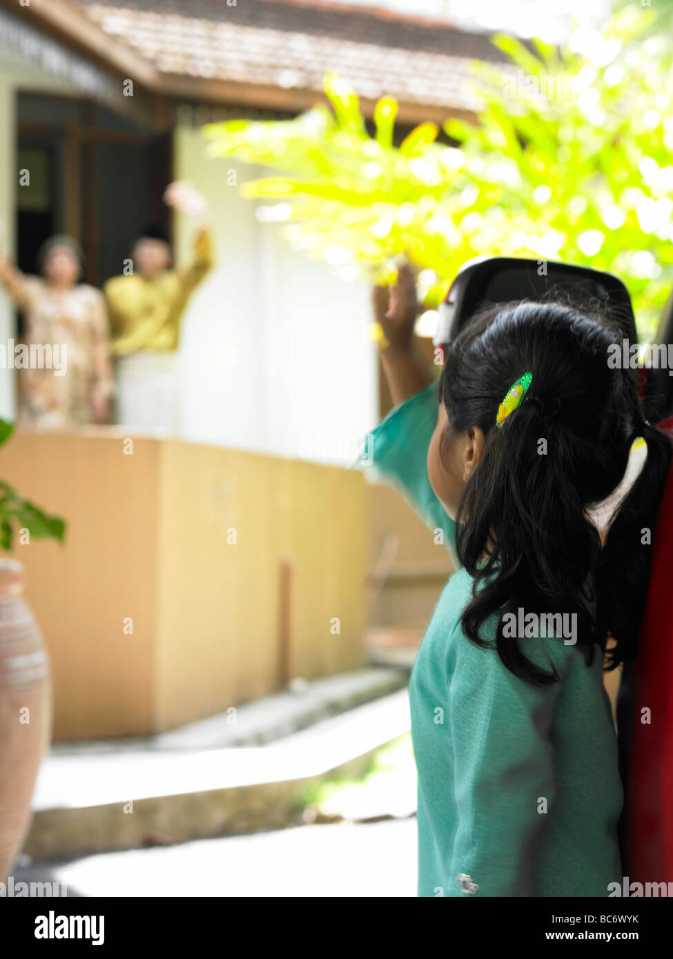 little girl waiving hand with grandparent Stock Photo - Alamy
