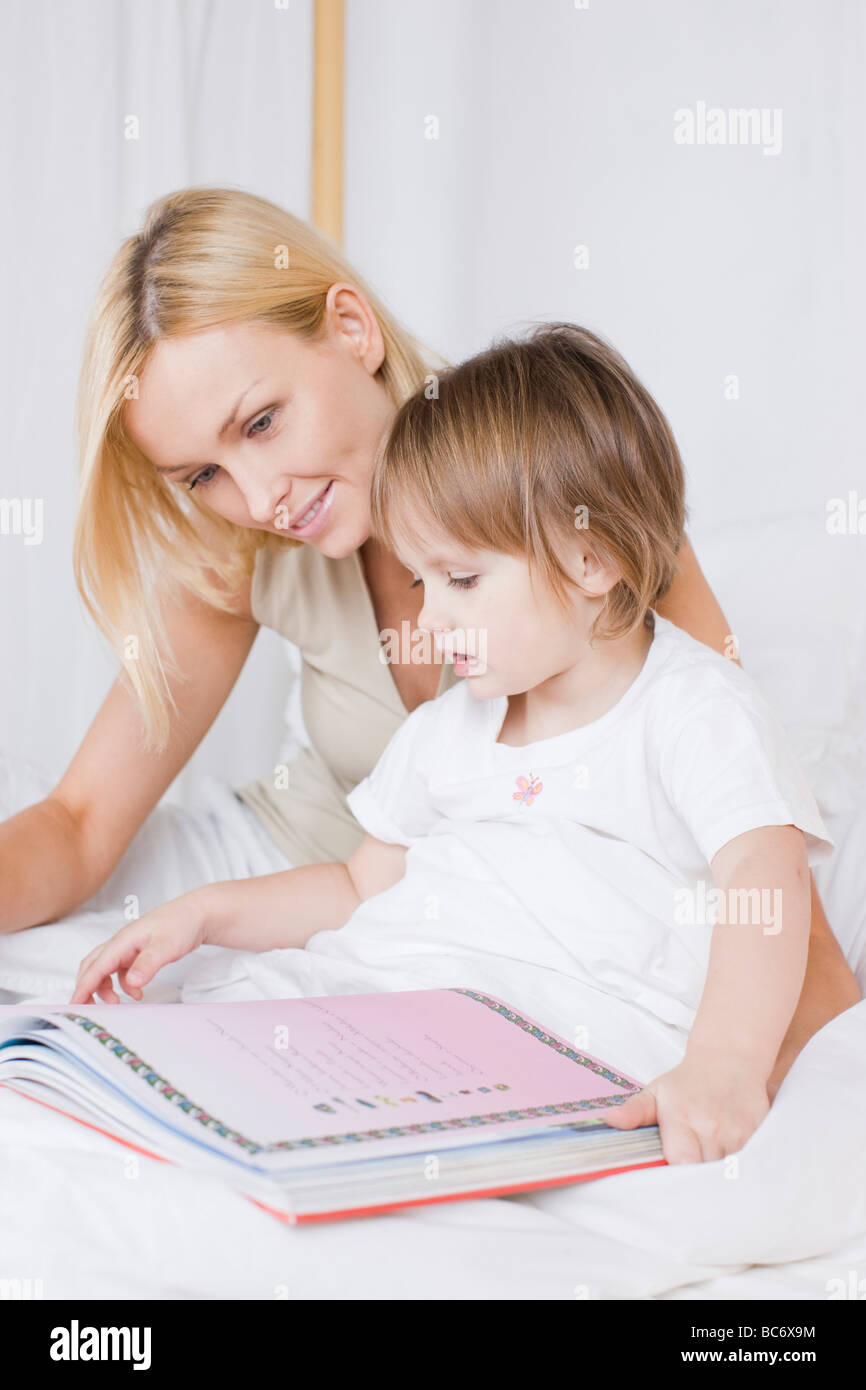mother and baby reading book Stock Photo - Alamy