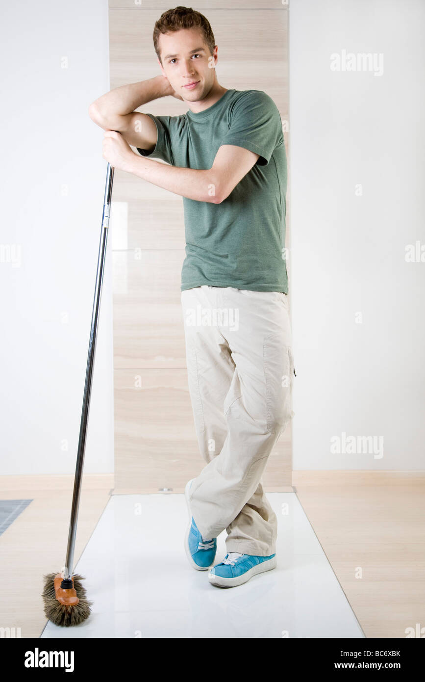 man holding broom Stock Photo - Alamy