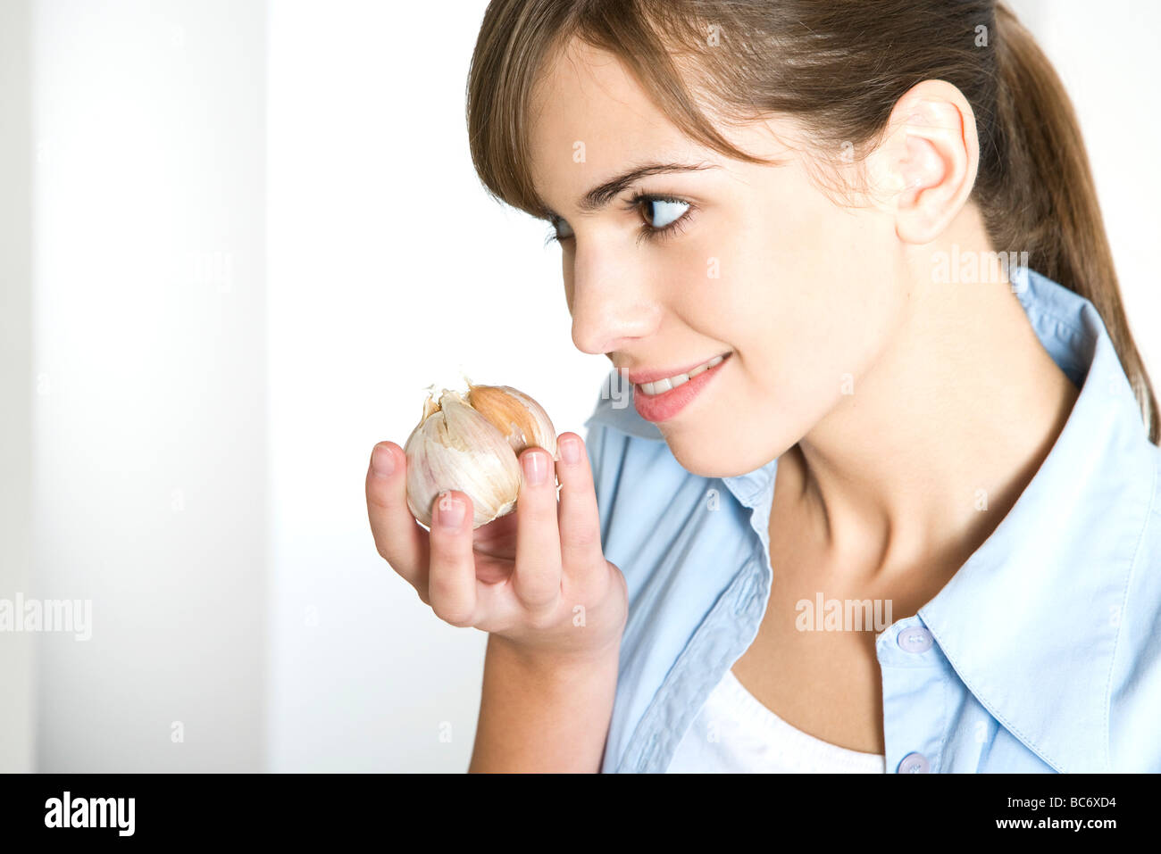 woman smelling garlic Stock Photo - Alamy