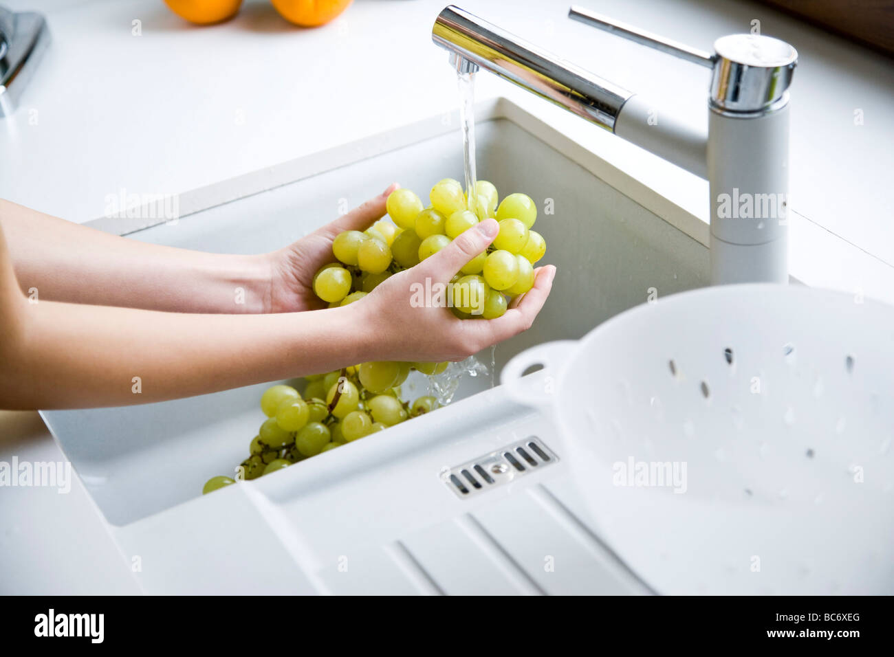 woman washing grapes Stock Photo - Alamy