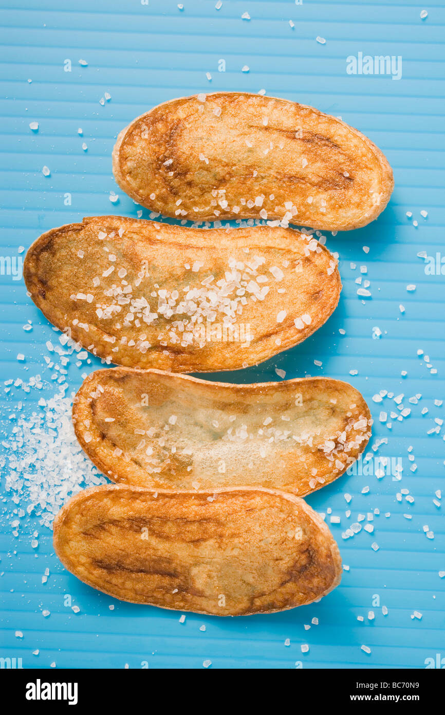 Four home-made potato crisps with salt Stock Photo - Alamy
