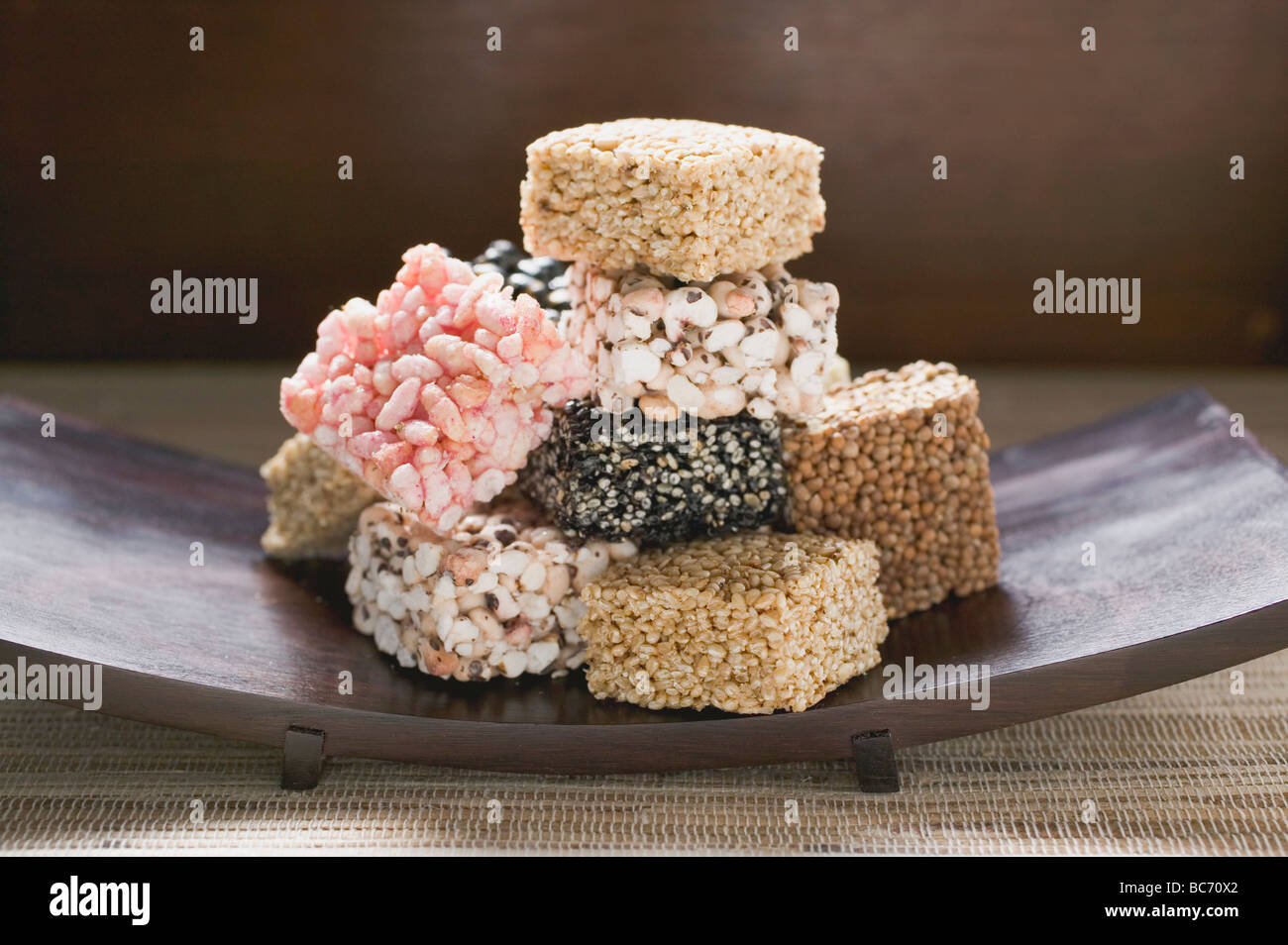 Asian sweets on wooden plate Stock Photo - Alamy