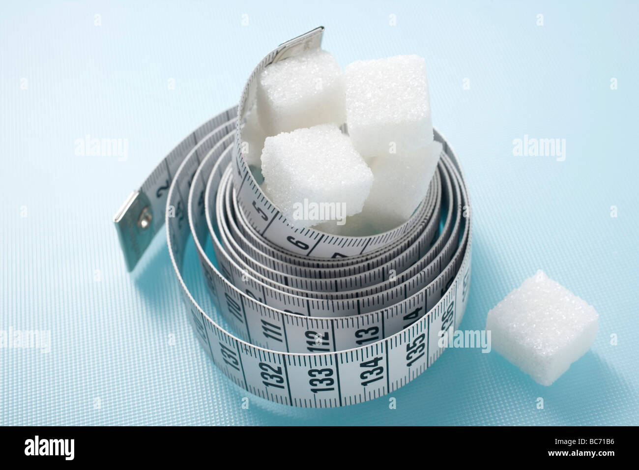 Tape measure and sugar cubes Stock Photo - Alamy