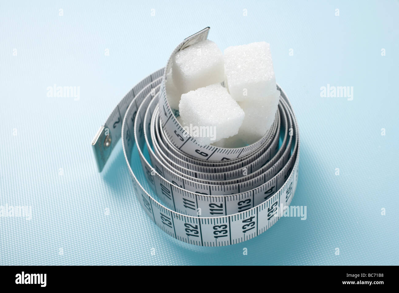 Tape measure and sugar cubes Stock Photo - Alamy