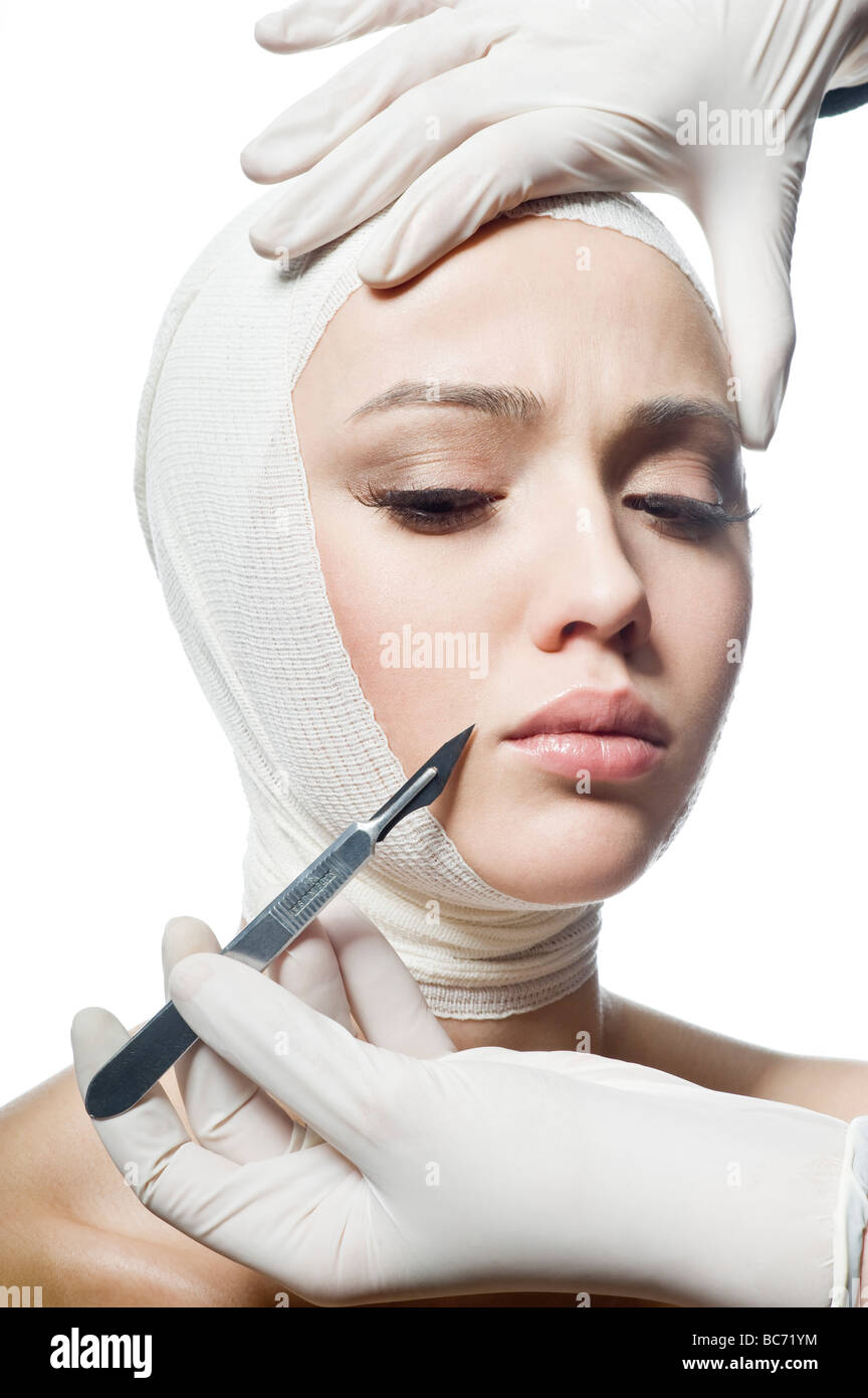 Hand holding a scalpel in front of face Stock Photo - Alamy