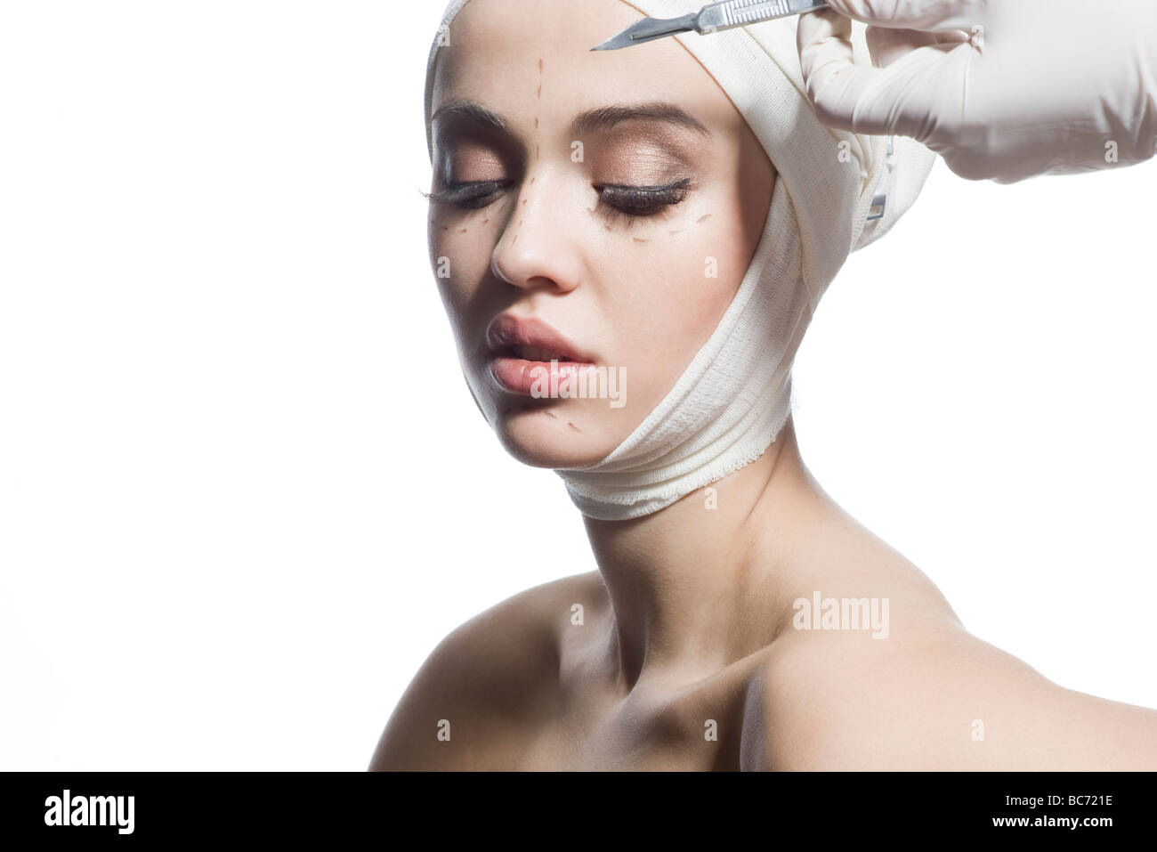 Hand holding a scalpel in front of face Stock Photo - Alamy