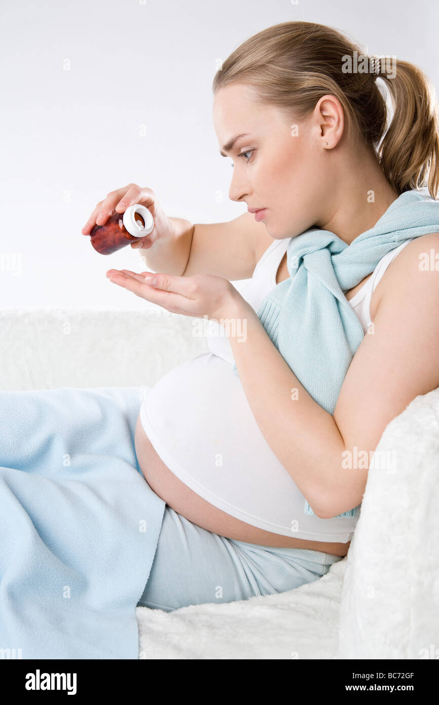 pregnant woman taking medicine Stock Photo - Alamy