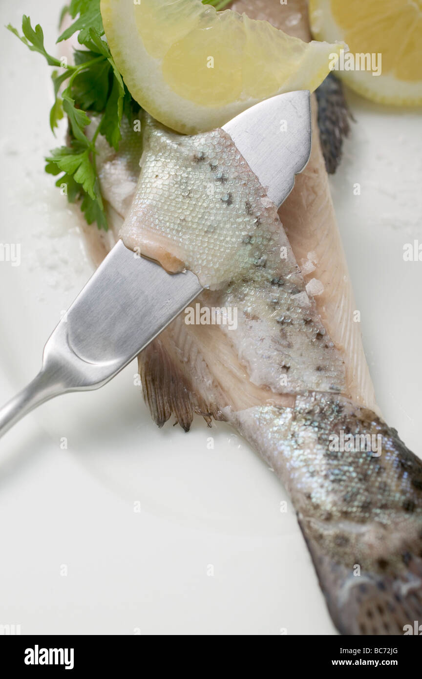 Removing skin from fish hi-res stock photography and images - Alamy