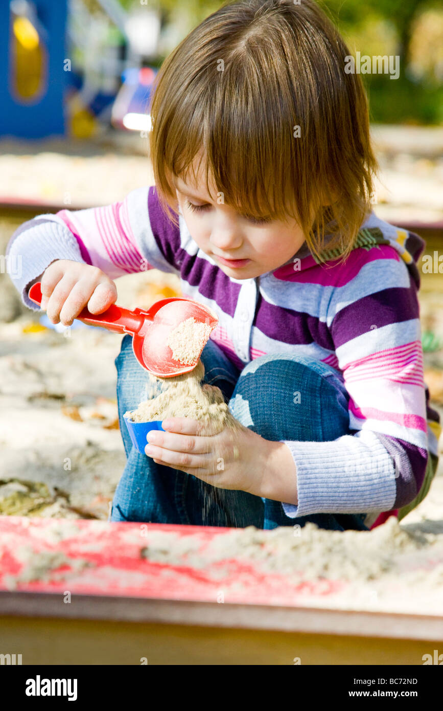 girl playing in sand pit Stock Photo - Alamy