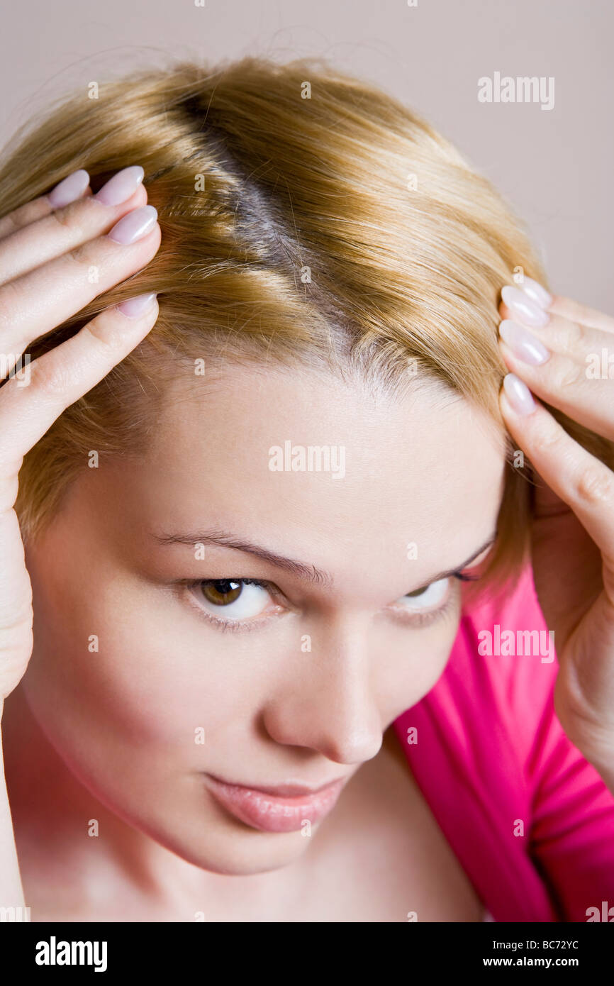 woman checking hair Stock Photo - Alamy