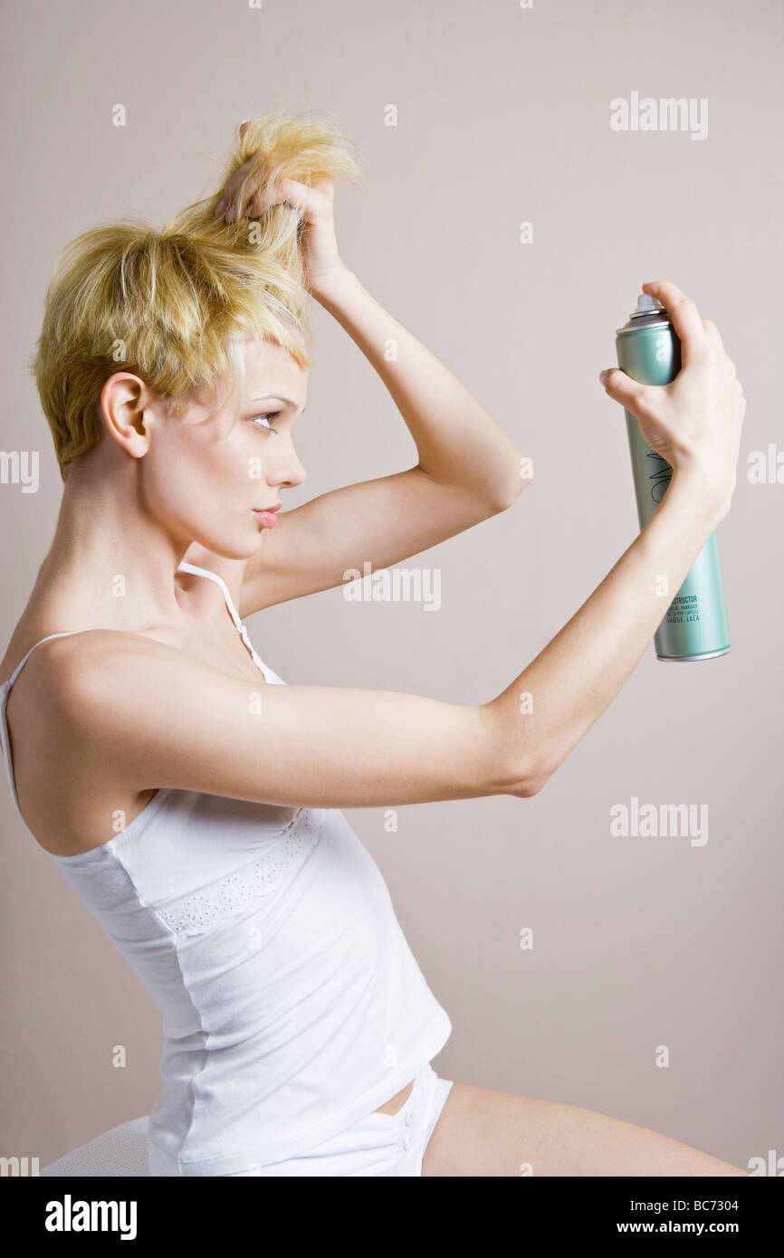 woman spraying hair Stock Photo - Alamy