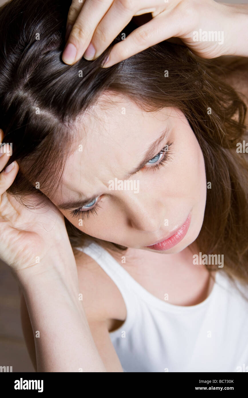 woman checking hair Stock Photo - Alamy