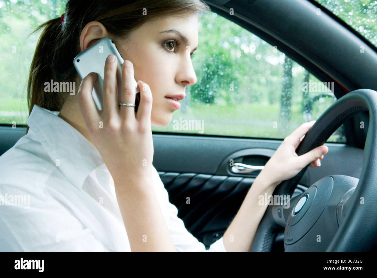 woman driving car and using mobile phone Stock Photo - Alamy