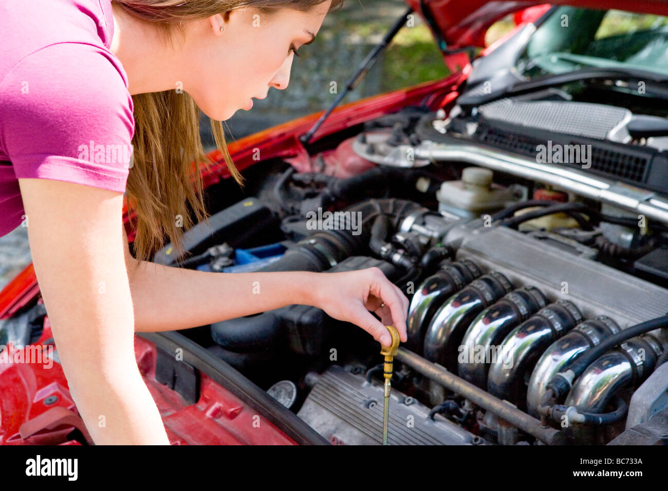 woman checking oil level in car Stock Photo - Alamy