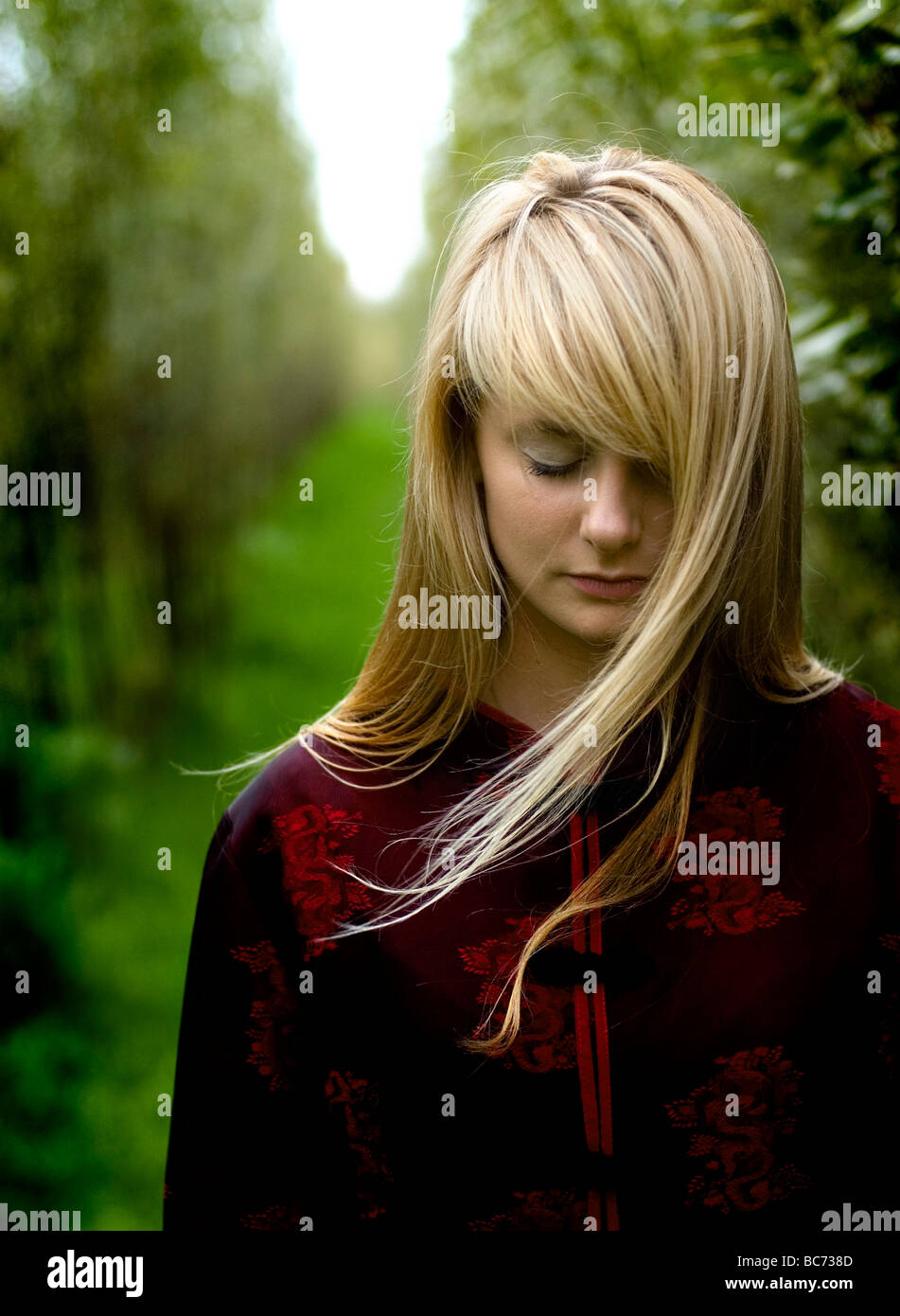 Sad woman in forest Stock Photo - Alamy