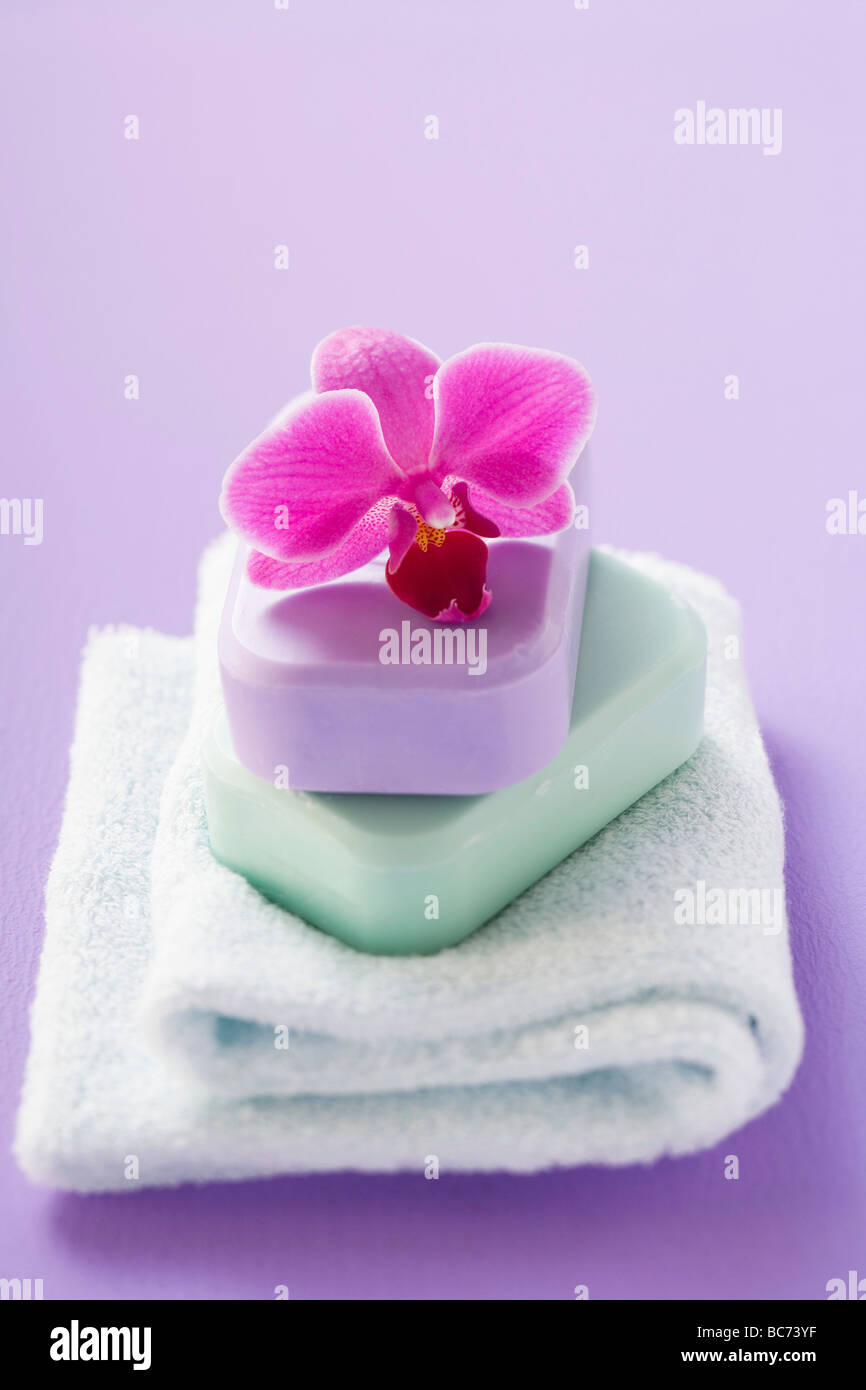 Two bars of soap with orchid on towel Stock Photo - Alamy