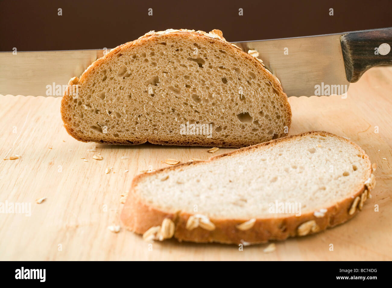 Wholemeal bread with rolled oats, partly sliced Stock Photo - Alamy