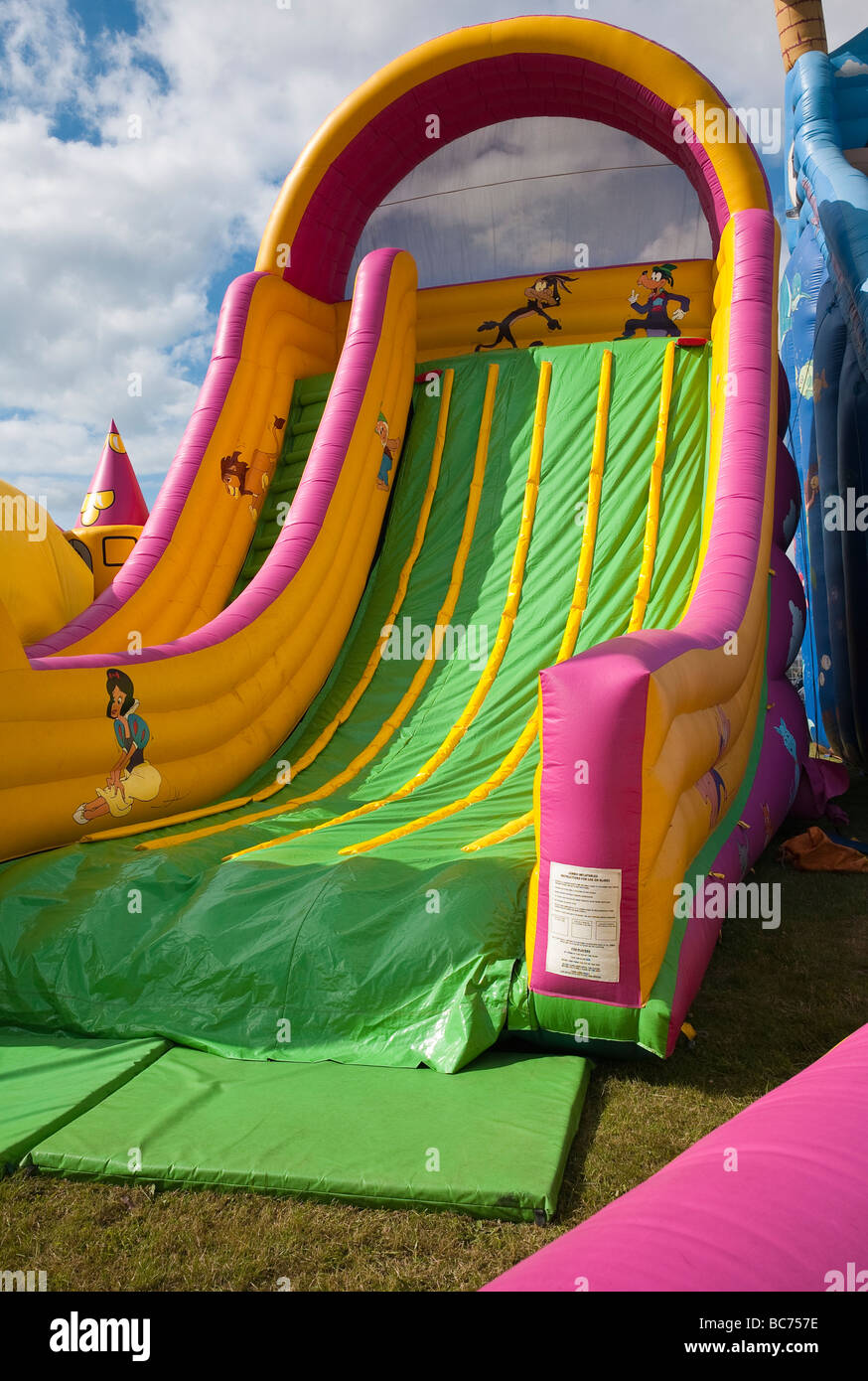 Inflatable slide awaiting customers at a fun fair Stock Photo - Alamy