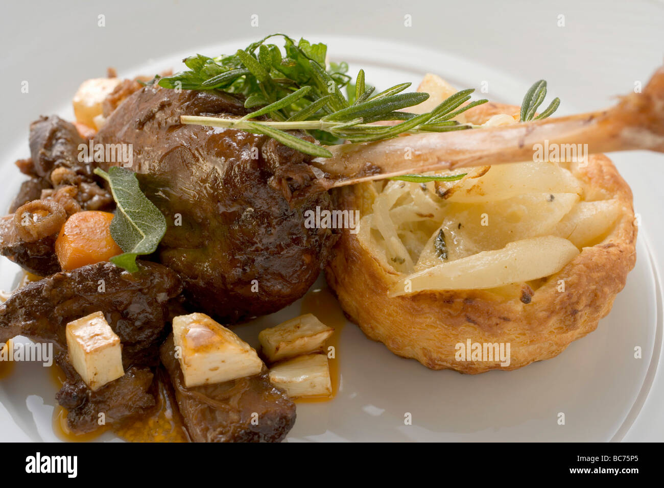 Braised goose leg with pear and onion tart Stock Photo - Alamy