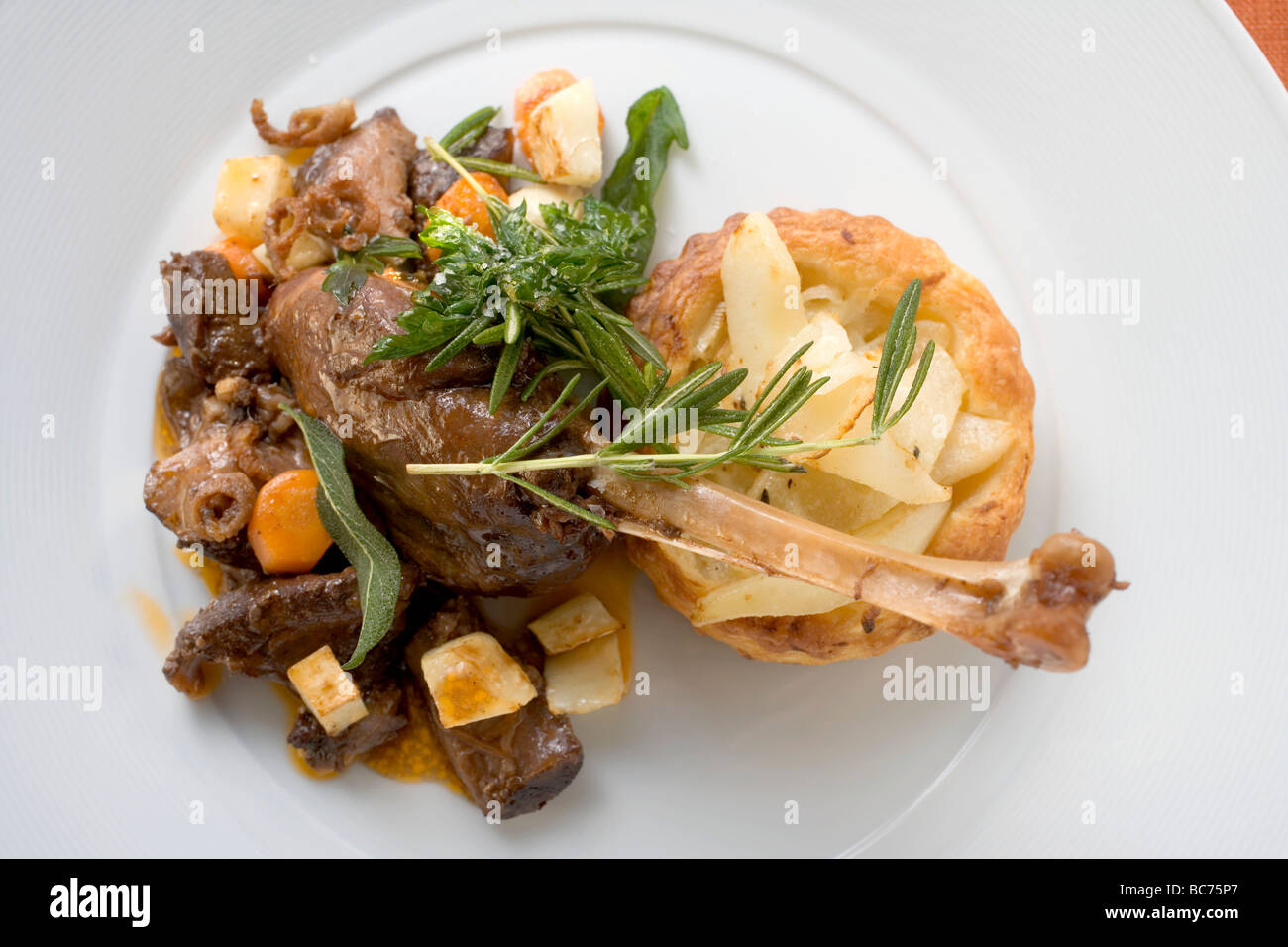Braised goose leg with pear and onion tart Stock Photo - Alamy