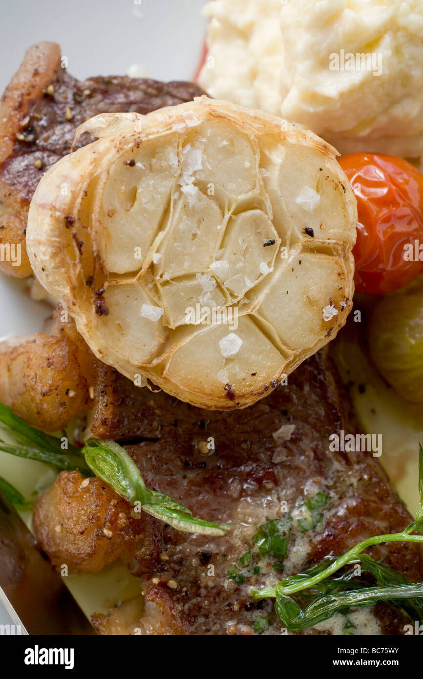 Beef steak with garlic bulb Stock Photo - Alamy