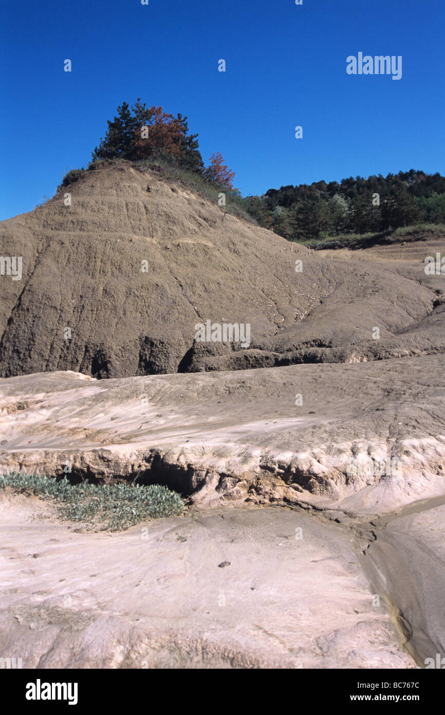 brown volcano with green hills and blue sky in background Stock Photo ...