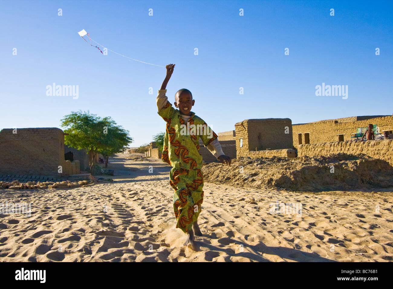 Malian Boy Pulling a Kite in Timbuktu Mali Stock Photo - Alamy
