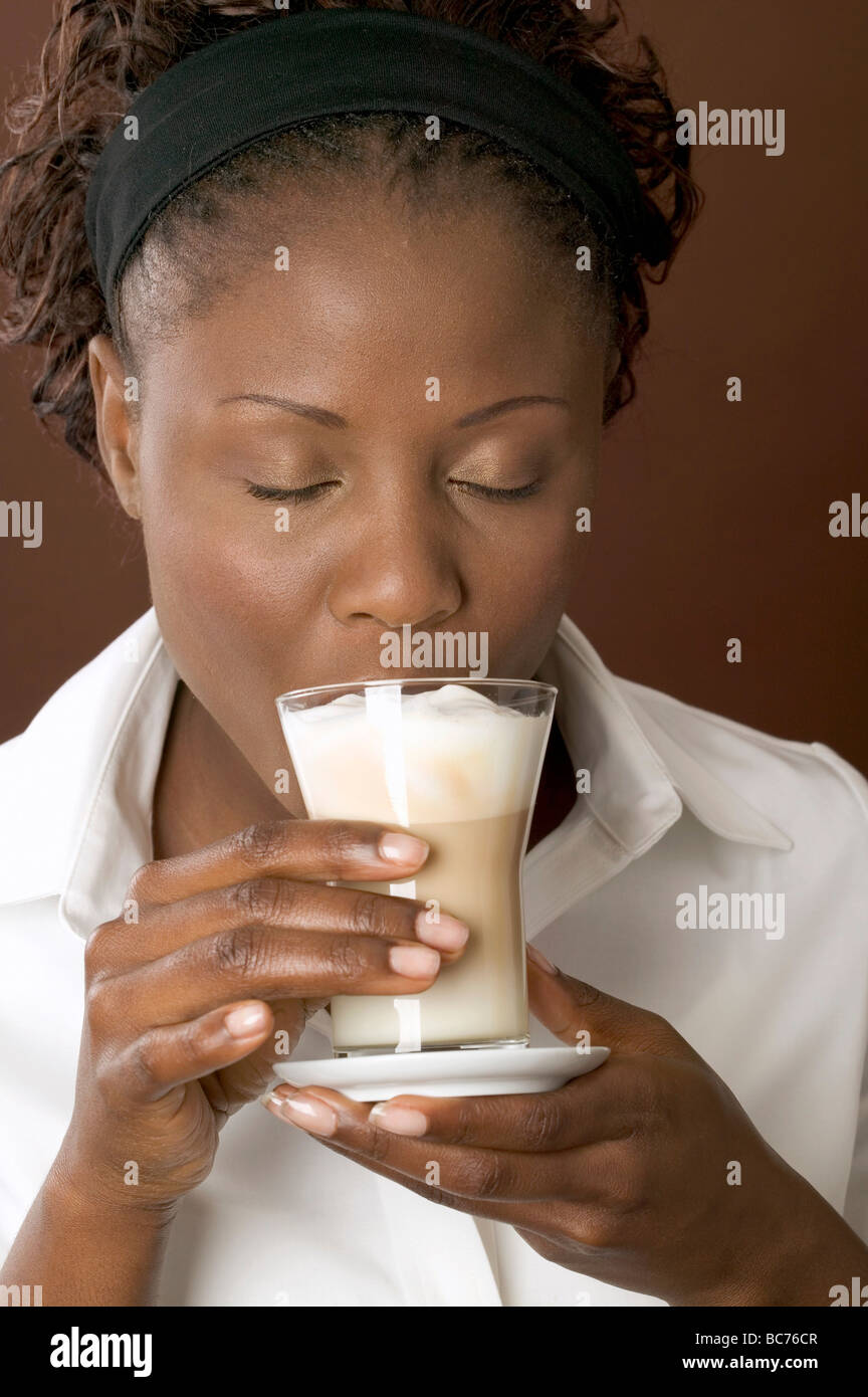 Woman drinking latte macchiato Stock Photo - Alamy