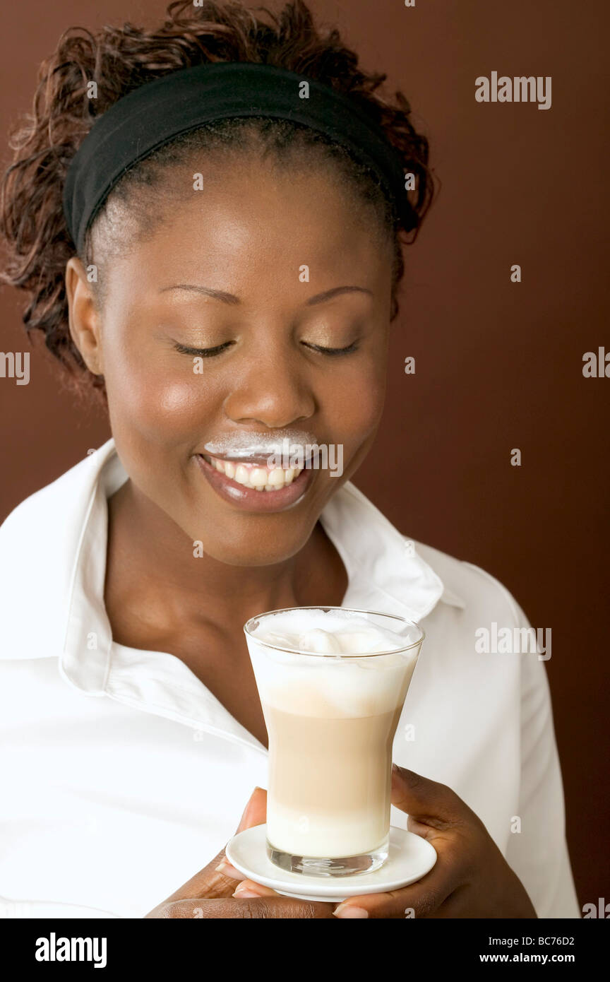 Woman drinking latte macchiato Stock Photo - Alamy
