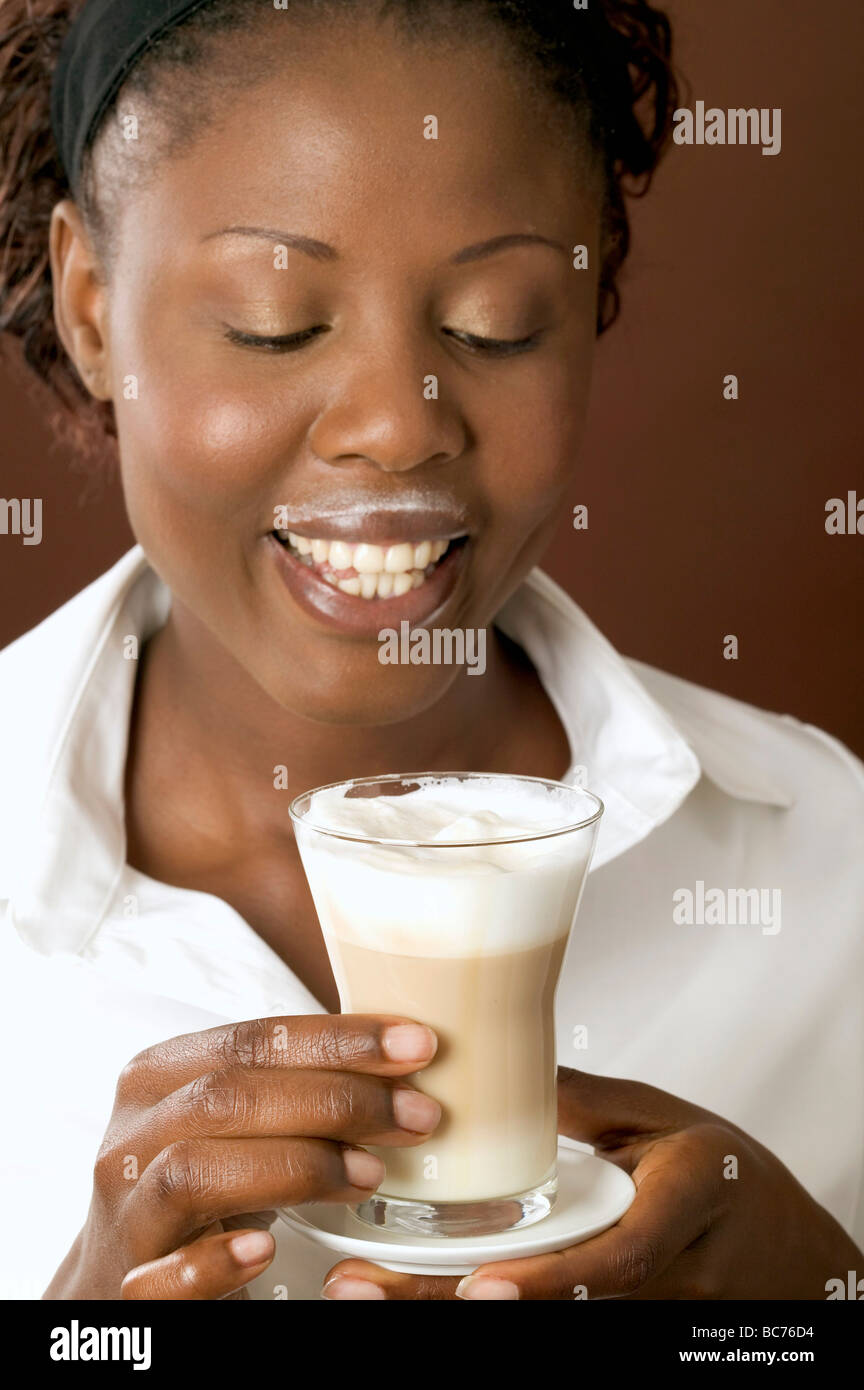 Woman drinking latte macchiato Stock Photo - Alamy